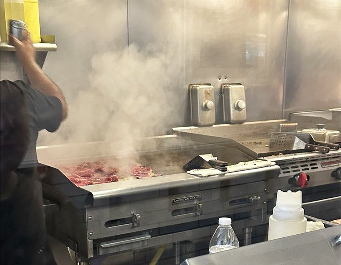 Steam rising from the grill like a culinary fog, carrying the intoxicating aroma of sizzling beef throughout Old City Philadelphia.