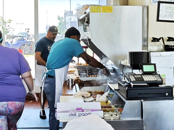 The grill masters at work, orchestrating a sizzling symphony of beef patties. This is where promises of deliciousness are kept.