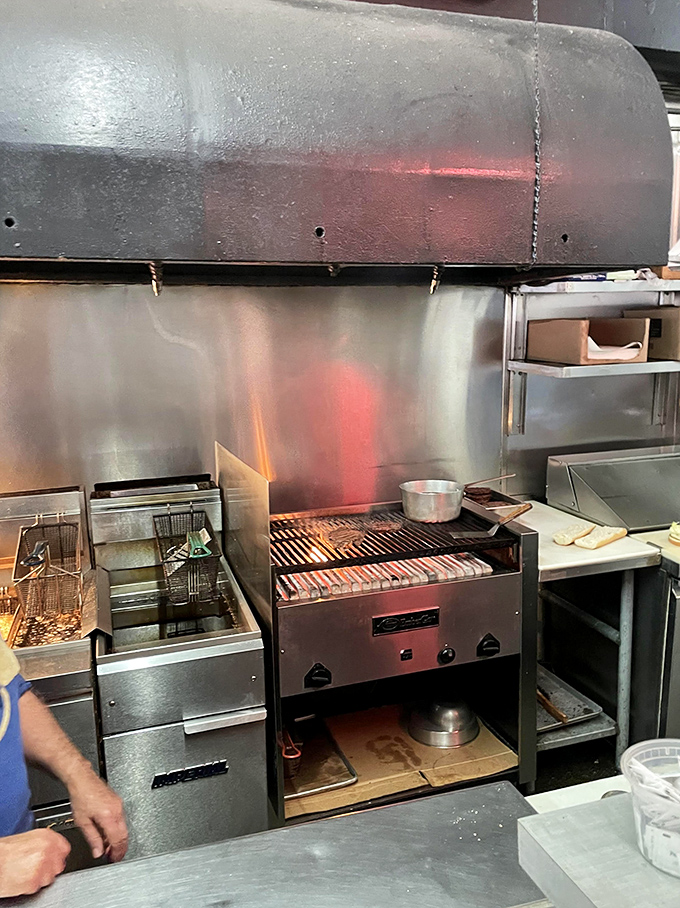 The kitchen's open flame reveals the sacred ritual where ordinary ingredients transform into extraordinary sandwiches before your eyes.