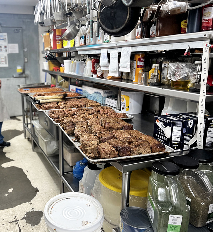 Behind the scenes, trays of what appear to be freshly made meatballs await their destiny. This is where the magic happens, folks.