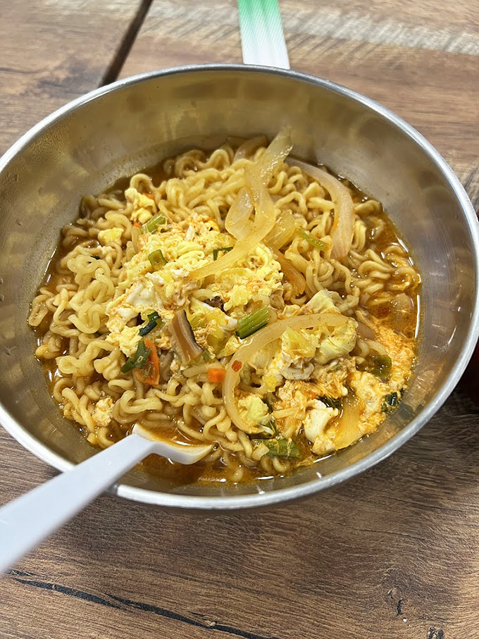 Steaming ramyun noodle soup arrives in its own pot, bringing authentic Korean comfort directly here.