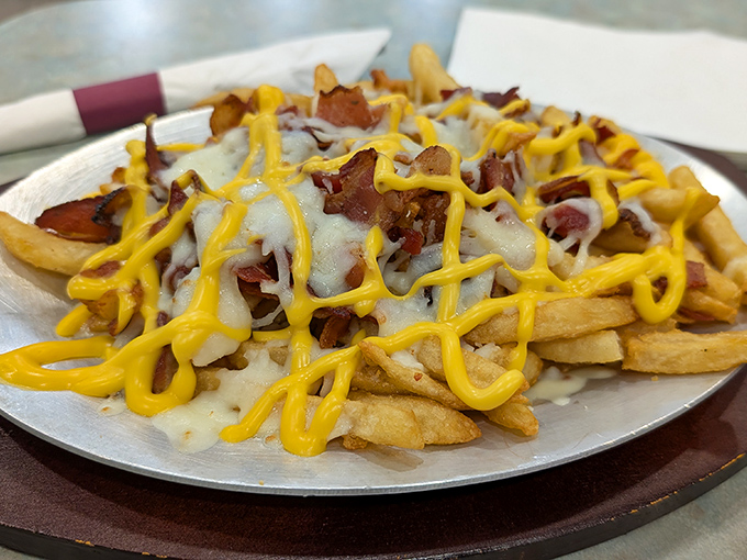 Loaded fries: where cheese, bacon, and potatoes have their most meaningful relationship. A beautiful yellow and white symphony.