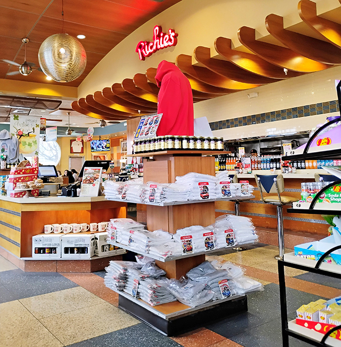 The merchandise corner says, "Yes, you can take home a t-shirt to remember us by, but your waistline won't let you forget anyway."