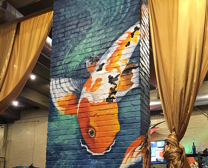 A koi mural that seems to swim up the brick wall. This splash of color transforms a simple column into an artistic statement about our connection to water.