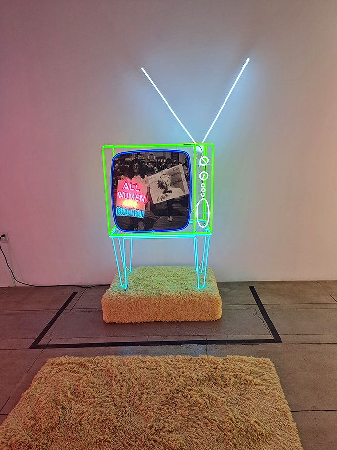 This neon television set doesn't just display images&mdash;it makes a glowing statement about how media itself shapes our collective consciousness.
