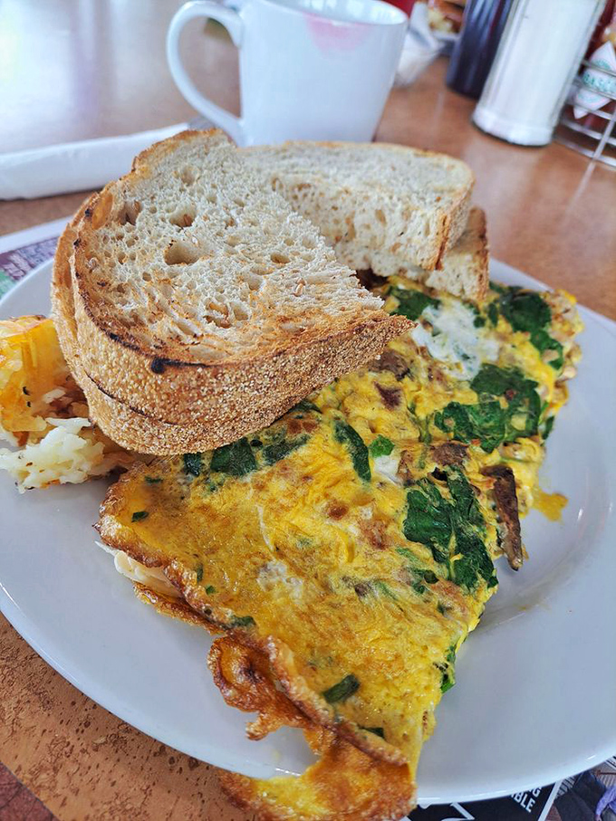 An omelet that's clearly been to college&mdash;educated with spinach and cheese while maintaining its down-to-earth potato sidekick.