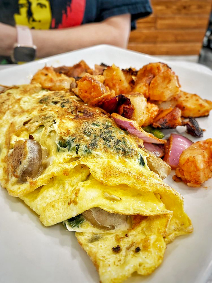 This isn't just an omelet&mdash;it's a masterclass in egg architecture, stuffed with veggies and paired with potatoes that have achieved crispy-tender nirvana.