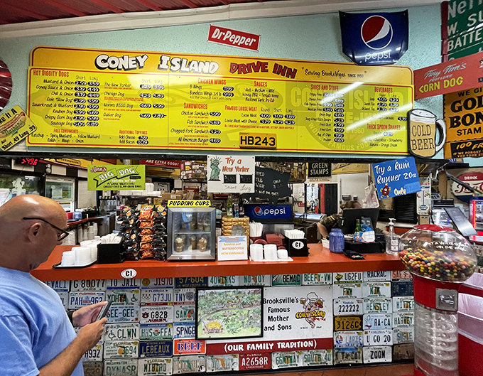 The order counter isn't just where food magic happens&mdash;it's a shrine to American road trips, decorated with license plates from dreams and journeys past. 