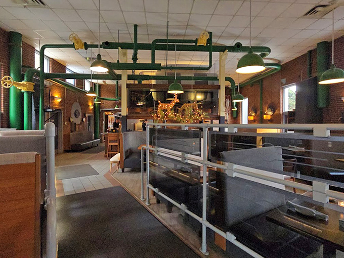 Green pipes snake overhead like industrial art installations, reminding diners of this building's powerful past.