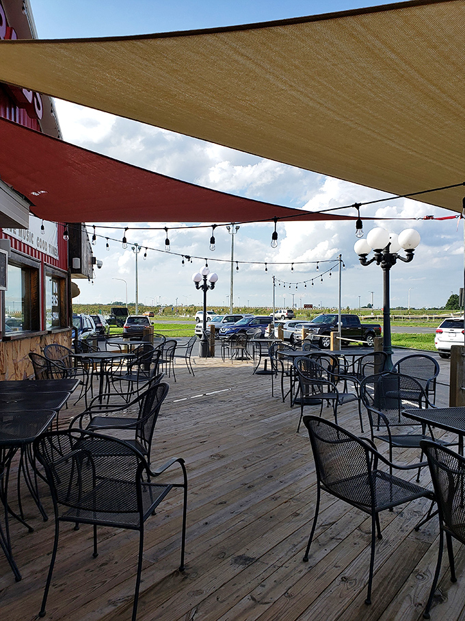 Outdoor dining under string lights and sail shades &ndash; because seafood always tastes better with a side of gentle breeze and open sky.