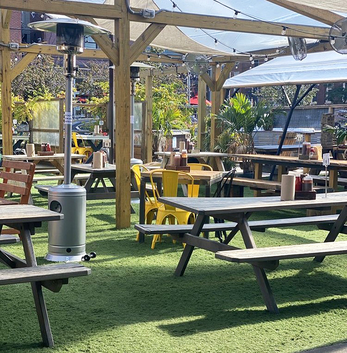 The outdoor patio at Walter's feels like the backyard BBQ of your dreams. Wooden pergolas, string lights, and picnic tables create the perfect summer vibe.