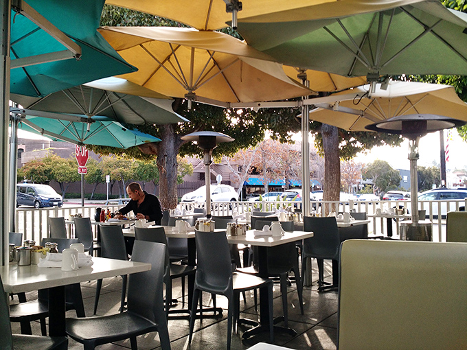 Al fresco dining under a canopy of umbrellas—because the only thing better than The Cottage's food is enjoying it in California's perfect weather.