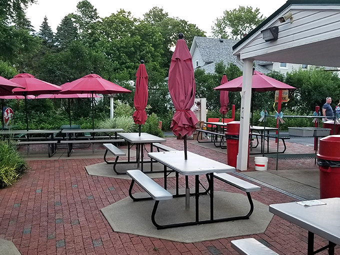 When Ohio summer evenings turn golden, these picnic tables become the best seats in town. The red brick patio feels more like someone's backyard than a restaurant—exactly as it should.