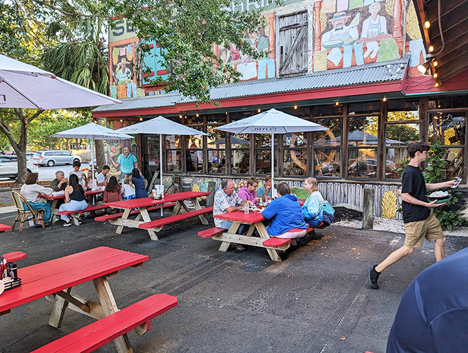 Red picnic tables under umbrellas offer the perfect spot for enjoying seafood in the Florida air. Casual dining at its finest.