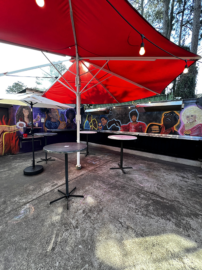 Al fresco dining with artistic flair. These standing tables under red umbrellas are where barbecue pilgrims gather to worship at the altar of smoke.