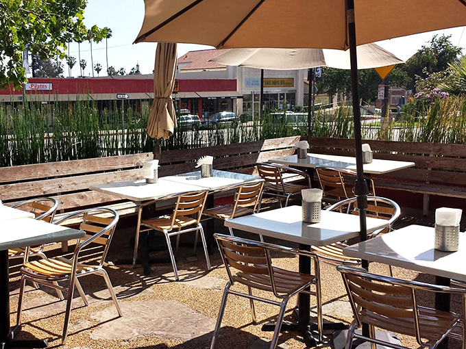 The outdoor patio&mdash;where palm trees stand guard over conversations, and the California sun blesses every bite with vitamin D and good vibes.