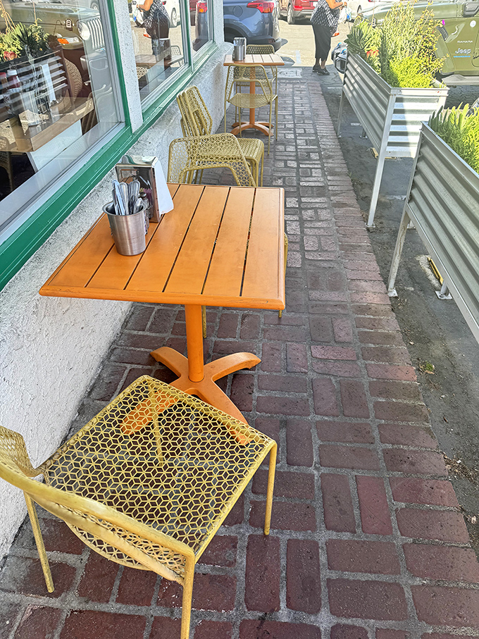 Sidewalk seating that whispers "linger a while" beneath the California sun. Even the chairs look like they're enjoying the weather.