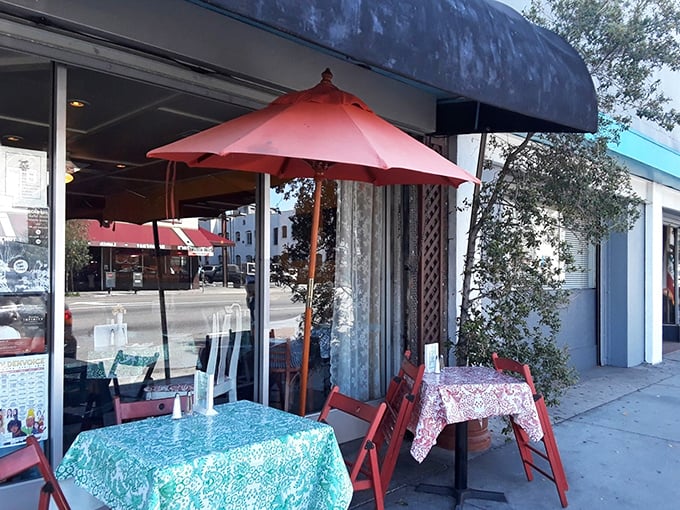 Sidewalk dining under red umbrellas &ndash; because great pizza tastes even better with a side of California sunshine.