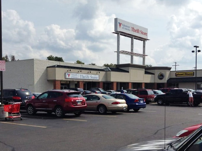 Thrift store exterior: where cars gather like hopeful prospectors at a modern-day gold rush. The treasures are inside, folks!