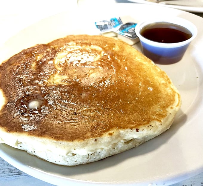 This pancake isn't just big—it's Florida big. Golden, fluffy, and ready to soak up maple syrup like a breakfast sponge.