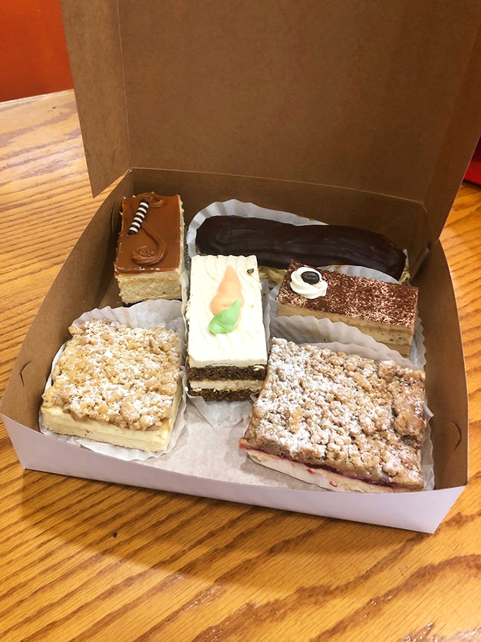 A display case that's basically the Louvre of baked goods – equally mesmerizing, infinitely more edible.