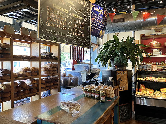 Fresh-baked breads and pastries line these shelves like edible works of art, each one promising to be the perfect vehicle for meats or the ideal sweet finale.