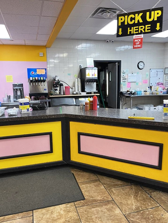 The pickup counter's bright yellow and pink color scheme is like a '80s music video that serves incredible sandwiches.