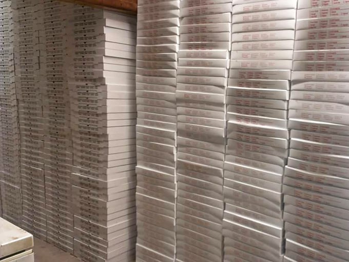 Behind the scenes: stacks of pizza boxes awaiting their noble purpose. Each one a vessel of joy ready to transport happiness to hungry homes.