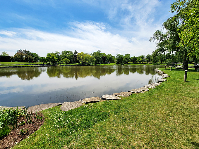 Reflections double the beauty at the park's serene pond. Mother Nature showing off her own artistic talents alongside human creations.