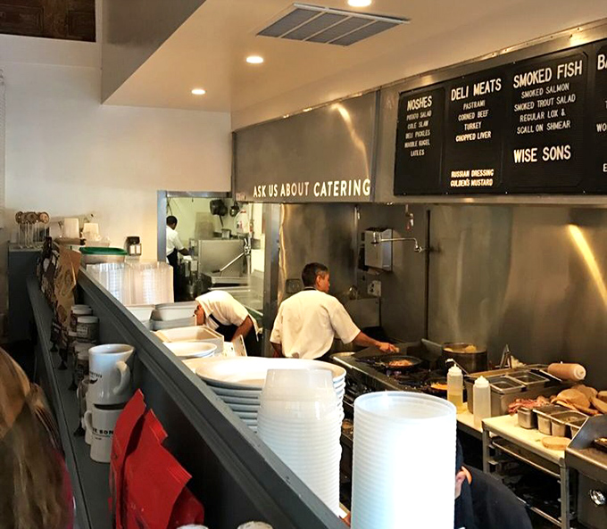 Behind-the-scenes magic where pastrami dreams become reality. The kitchen choreography is as precise as a Seinfeld episode setup.