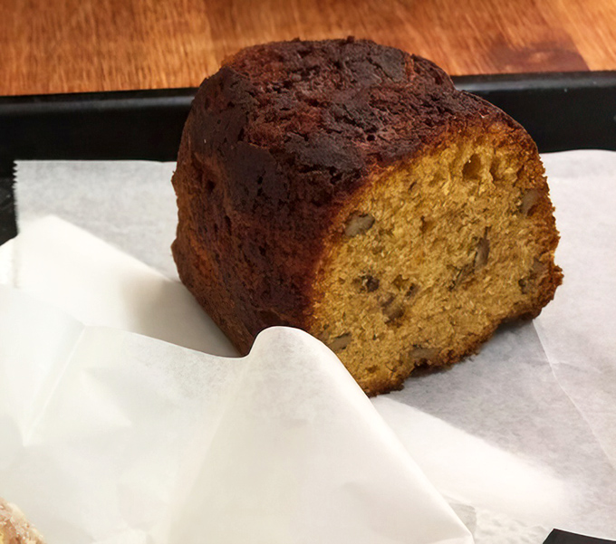 This slice of pumpkin bread looks unassuming but delivers complex spice notes that dance across your taste buds like autumn leaves in a gentle breeze.