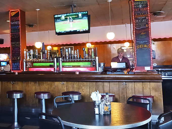Cozy booths and tables await your hot dog adventures. The warm lighting makes everyone look good while contemplating their next topping combination.