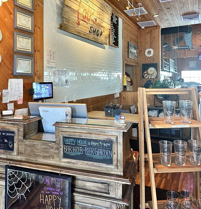 The host stand welcomes with rustic charm and a happy hour chalkboard. First impressions matter, and this one says "coastal casual done right."