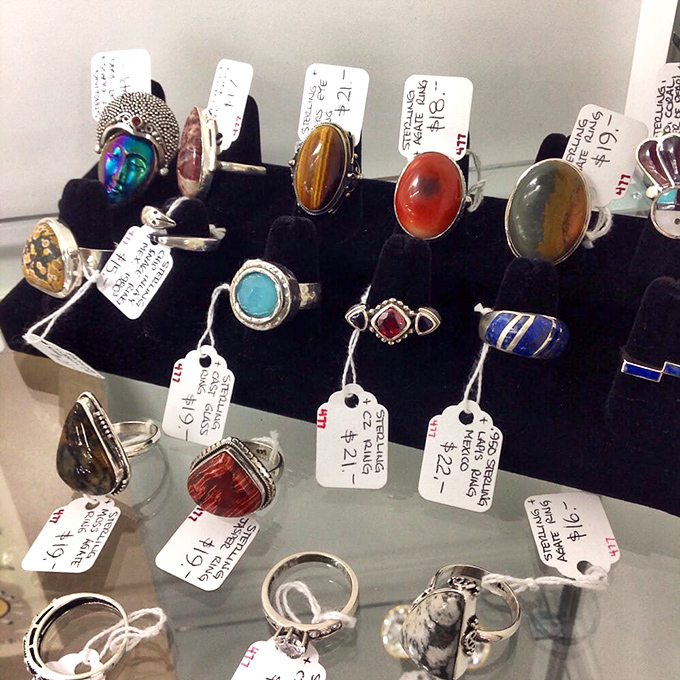 Vintage rings displayed like tiny time capsules, each one a promise or memory frozen in metal.