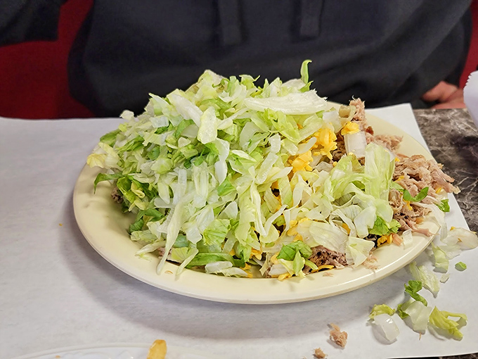 A salad so generous it's practically wearing a "bless your heart" t-shirt. Fresh greens playing host to a family reunion of toppings.