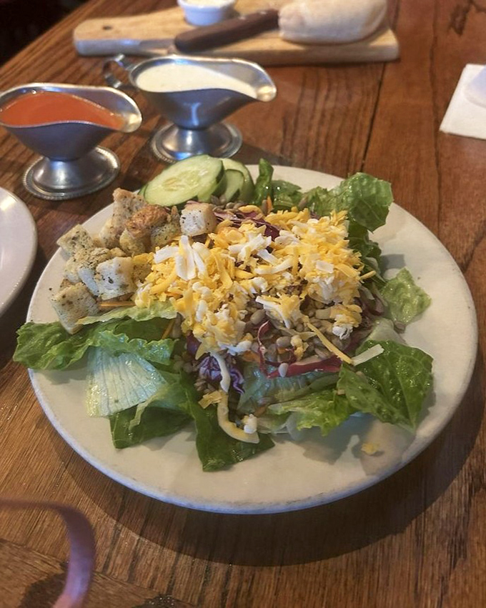 A salad that actually deserves attention&mdash;fresh greens, shredded cheese, and house-made croutons that aren't just filling time before the main event.