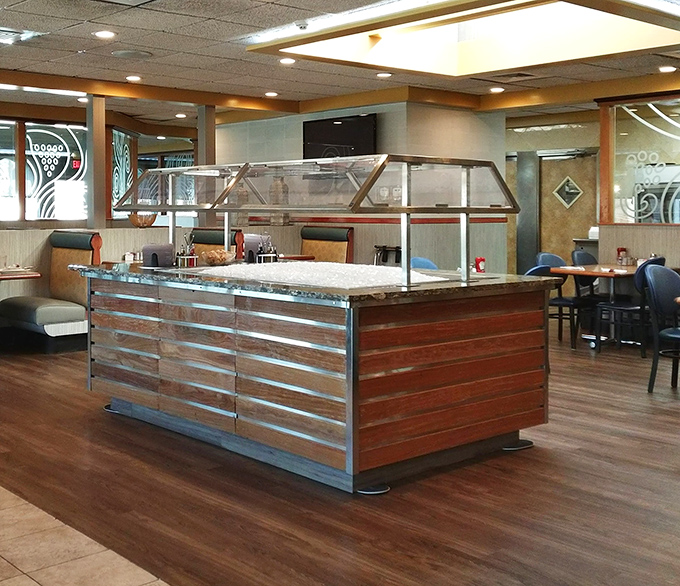 The salad bar island stands ready for those who want to pretend they're being virtuous before inevitably ordering dessert anyway.