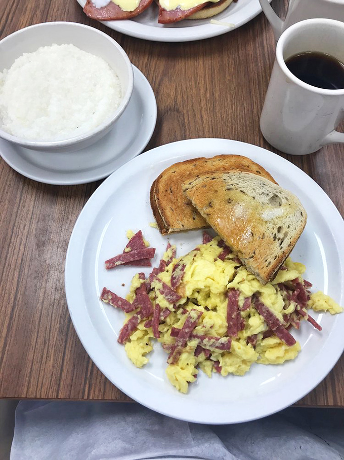Scrambled eggs mingling with salami like old friends at a reunion. The toast stands by, ready to soak up every last bit of flavor.