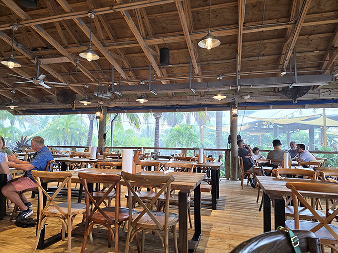Dining room with a view that makes you wonder why we ever invented walls. Those wooden ceiling fans are just for show—the bay breeze does all the work.