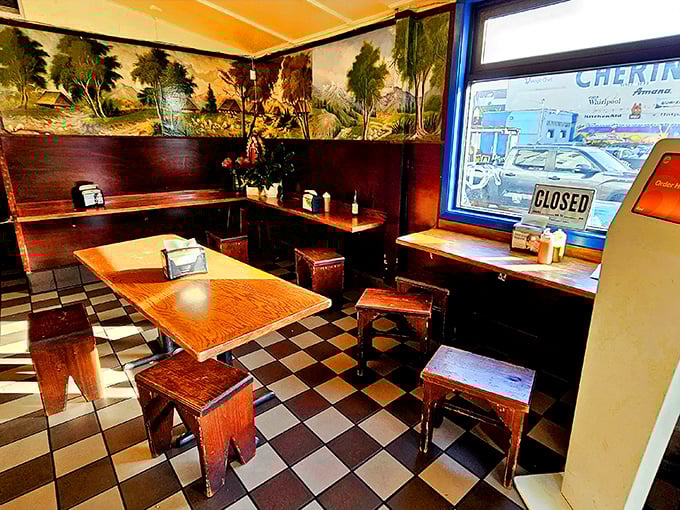 The dining room feels like your abuela's house, if your abuela had a thing for checkered floors and landscape paintings.