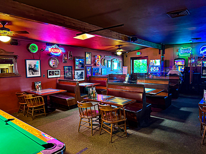 The lounge glows with neon warmth, where vinyl booths have witnessed first dates, last calls, and everything worth celebrating in between.