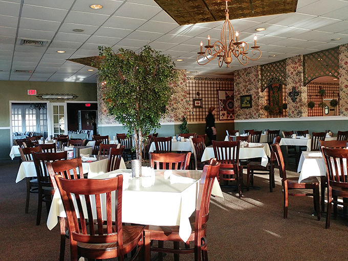 Dining room chandeliers cast a warm glow over tables where memories are made between bites of homestyle cooking. 