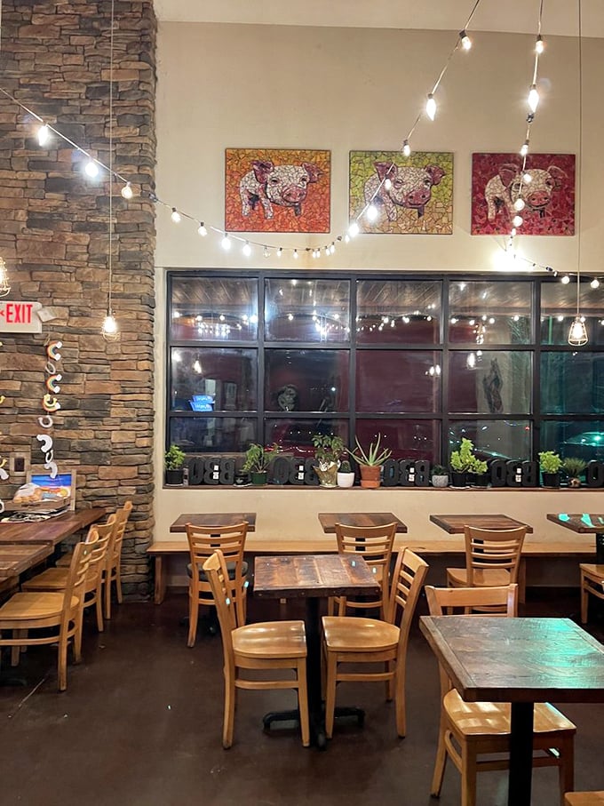 Pig-themed artwork watches over diners like barbecue guardian angels while string lights create the perfect ambiance for meat-induced happiness. 