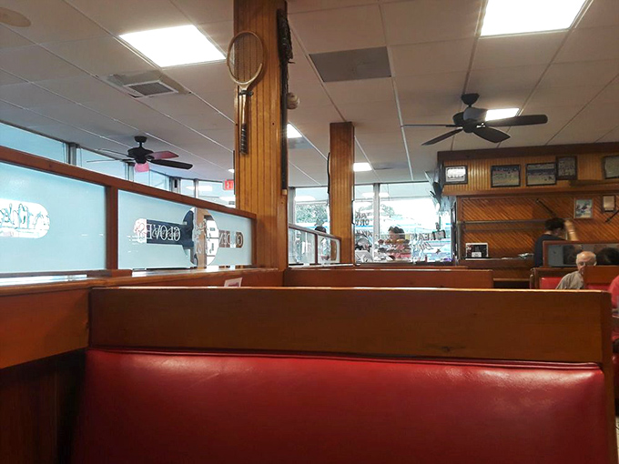 Red booths that have cradled countless conversations and wooden dividers that have heard more Miami secrets than a hairdresser on South Beach.