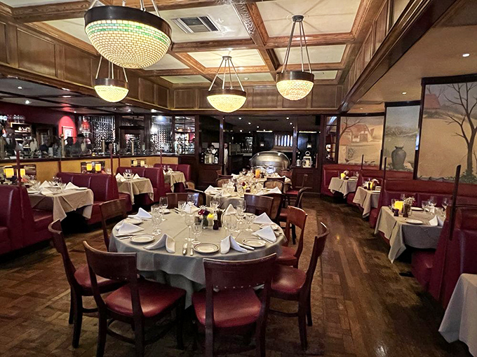 Round tables and burgundy banquettes create intimate dining spaces perfect for celebrating life's most delicious moments.