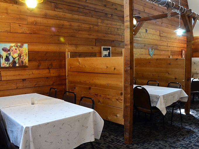Private dining booths with rustic wood dividers create little sanctuaries for intimate conversations and serious eating.