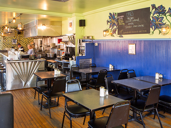 The blue wainscoting and yellow walls create a cheerful backdrop for serious eating—like dining inside a happy little breakfast kingdom.