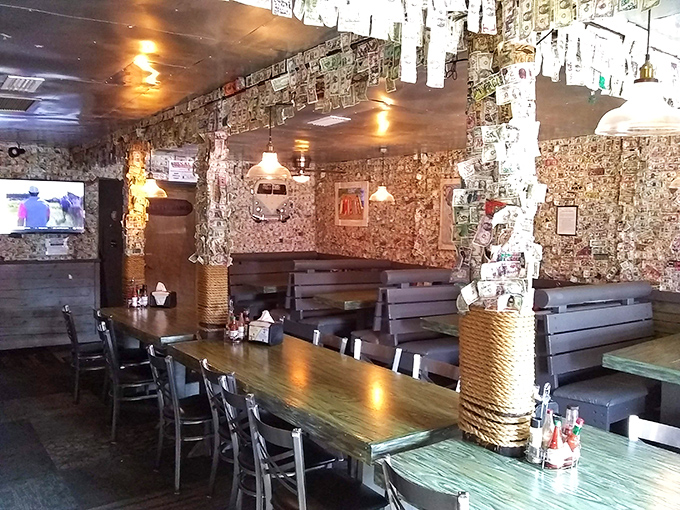 Dollar bills wallpapering every surface like the world's most expensive interior design choice. Those wooden booths have heard more seafood stories than a fisherman's convention.