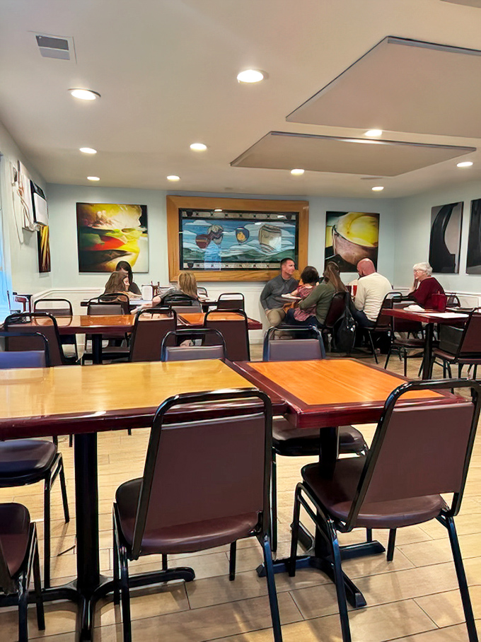 Modern art brightens walls in the dining area, where simple wooden tables have hosted countless family celebrations and first dates.