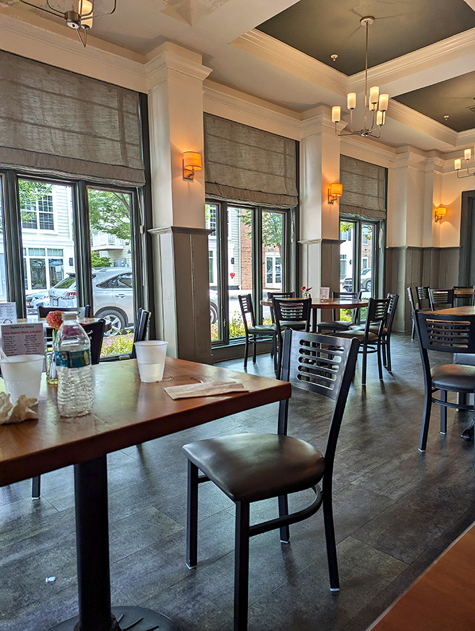 Tall windows invite the outside world to peek in at the lucky diners, while elegant Roman shades stand ready to filter the afternoon sun.